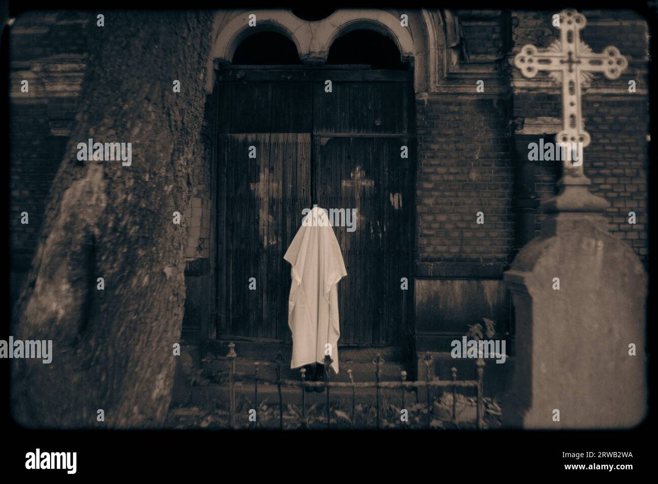 In this eerie Halloween photograph, a ghostly figure stands on the ...