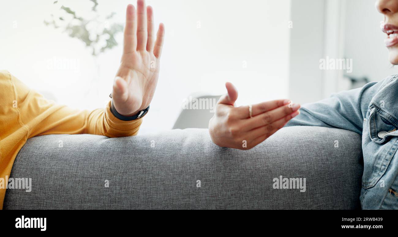 Argument, hands and closeup of couple on a sofa in the living room for ...