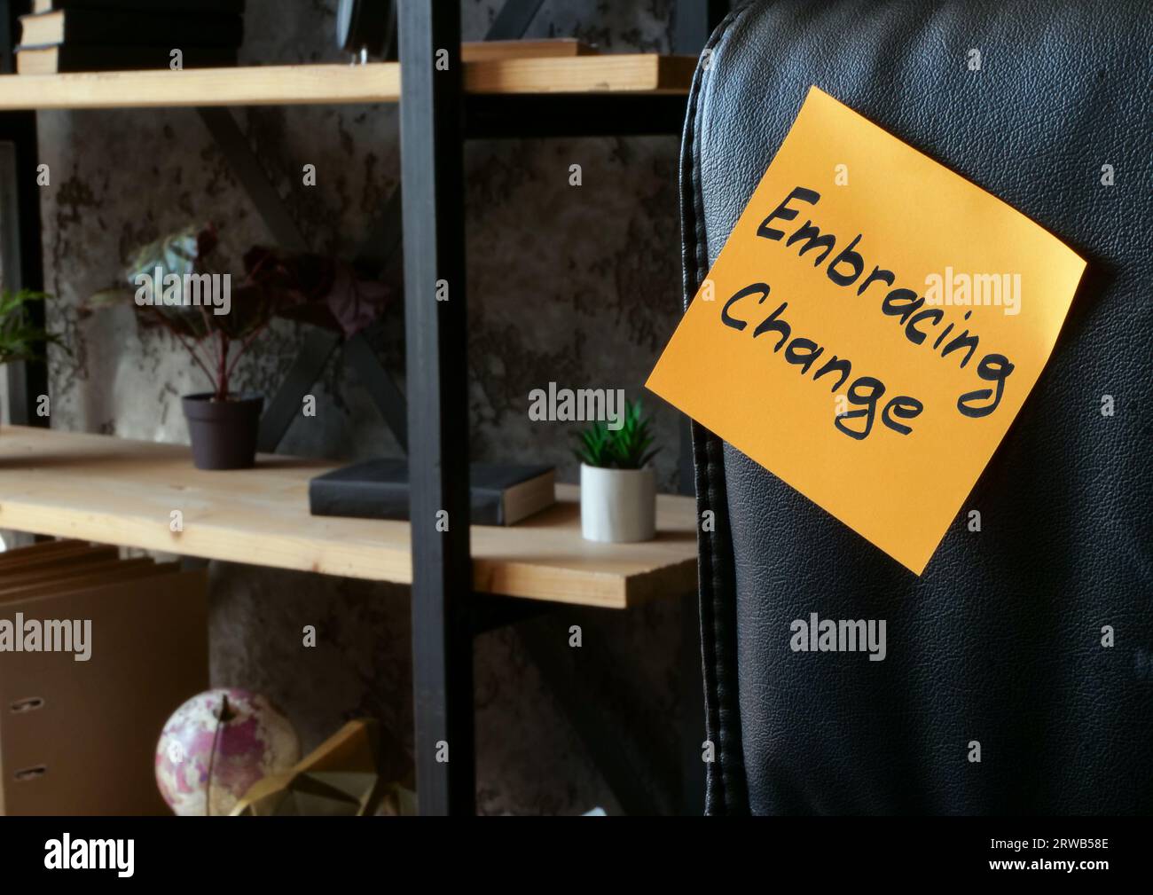 Sticker with the inscription Embracing change is attached to the office ...