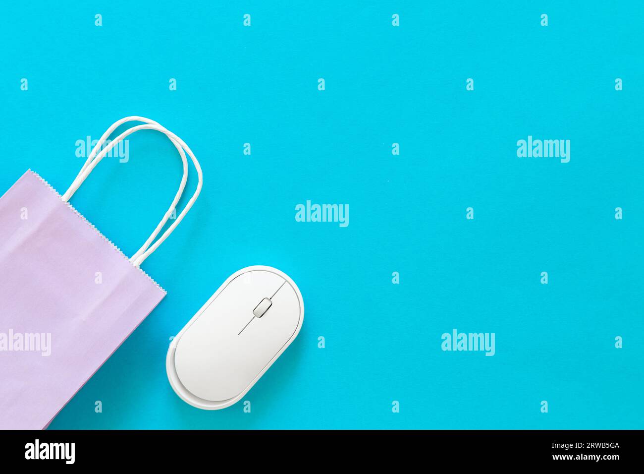Computer mouse and paper bag on a blue background, top view Stock Photo ...