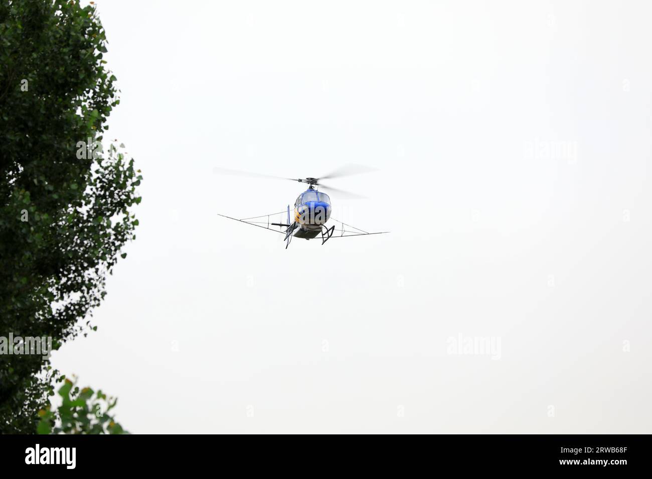 Agricultural helicopters fly in the sky Stock Photo - Alamy