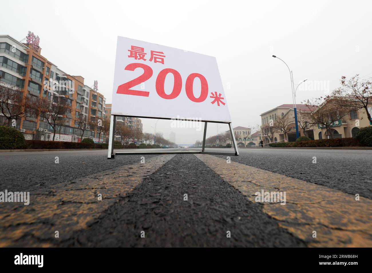 "The last 200 meters" was written on a white bulletin board at a road ...