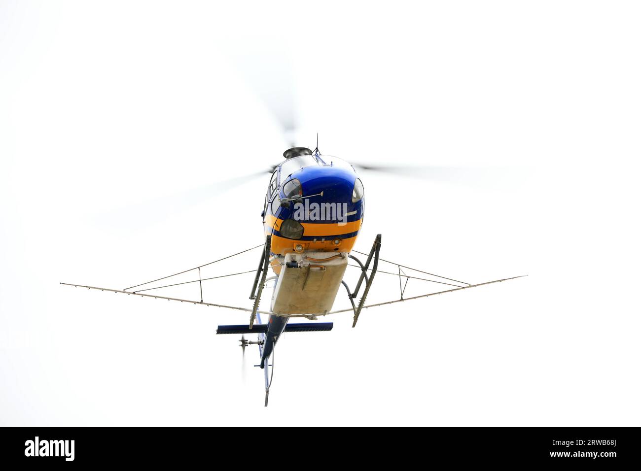 Agricultural helicopters fly in the sky Stock Photo - Alamy