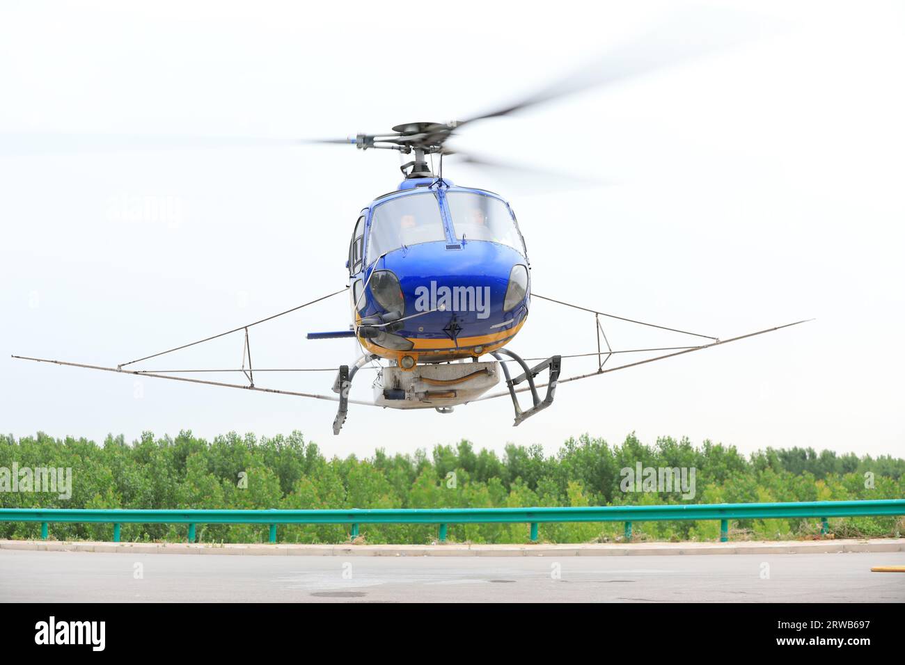 Agricultural helicopters fly in the sky Stock Photo - Alamy