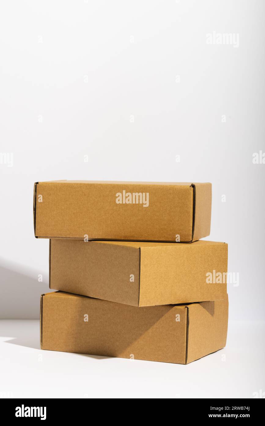 Vertical image of stack of cardboard gift boxes with copy space over ...