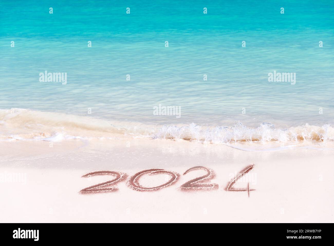 2024 written on white sand hi-res stock photography and images - Alamy