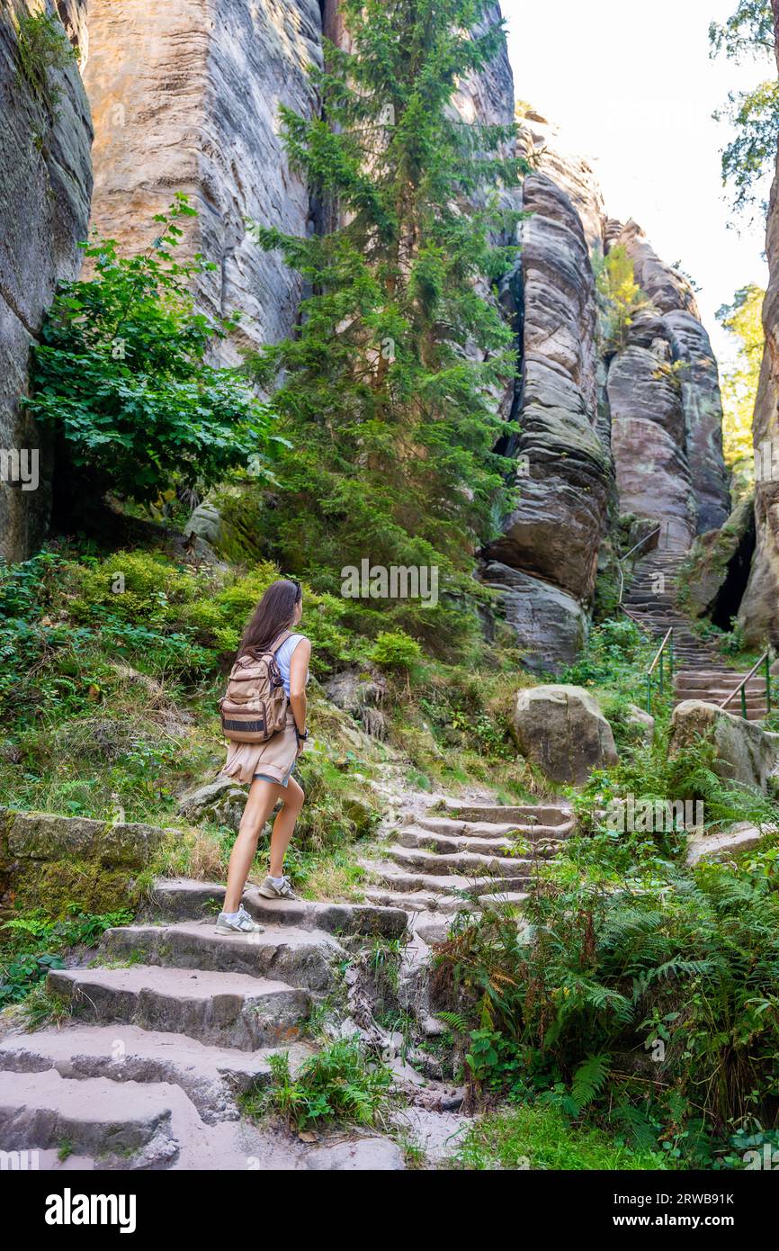 Tourist in Prachovske skaly in sun lights, Cesky raj sandstone cliffs ...