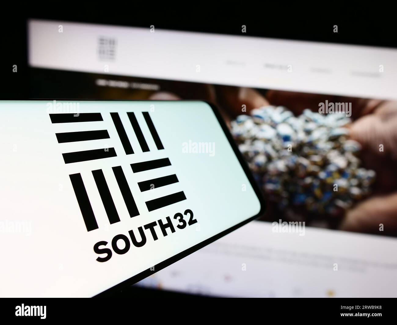 Mobile phone with logo of Australian mining company South32 Limited on ...