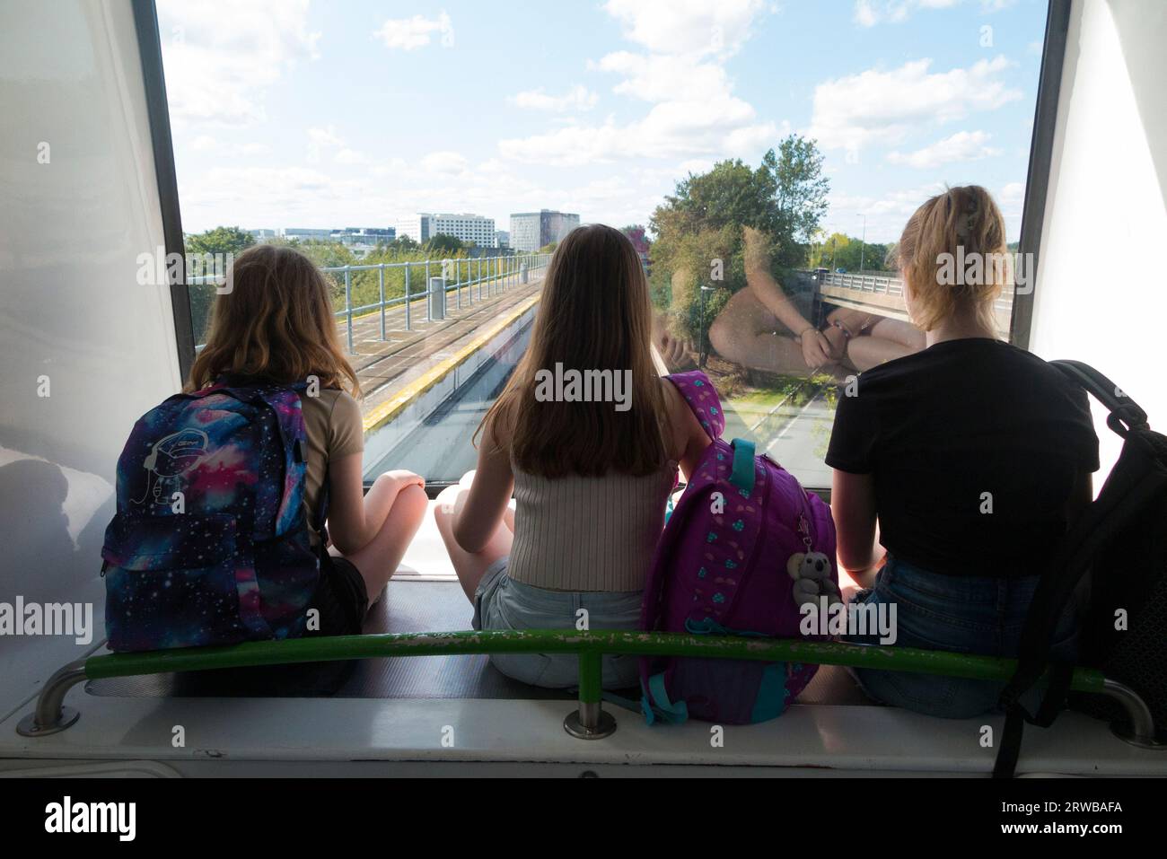 Three sisters, children, kids, ride the inter-terminal shuttle service ...