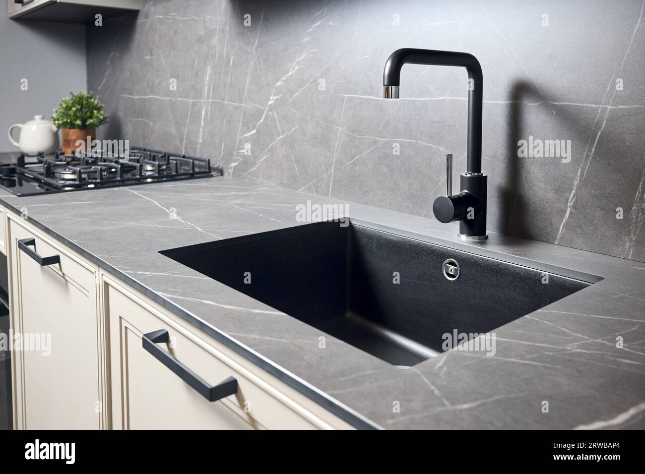 Compact undermount sink. Kitchen sink area with black square matte sink ...
