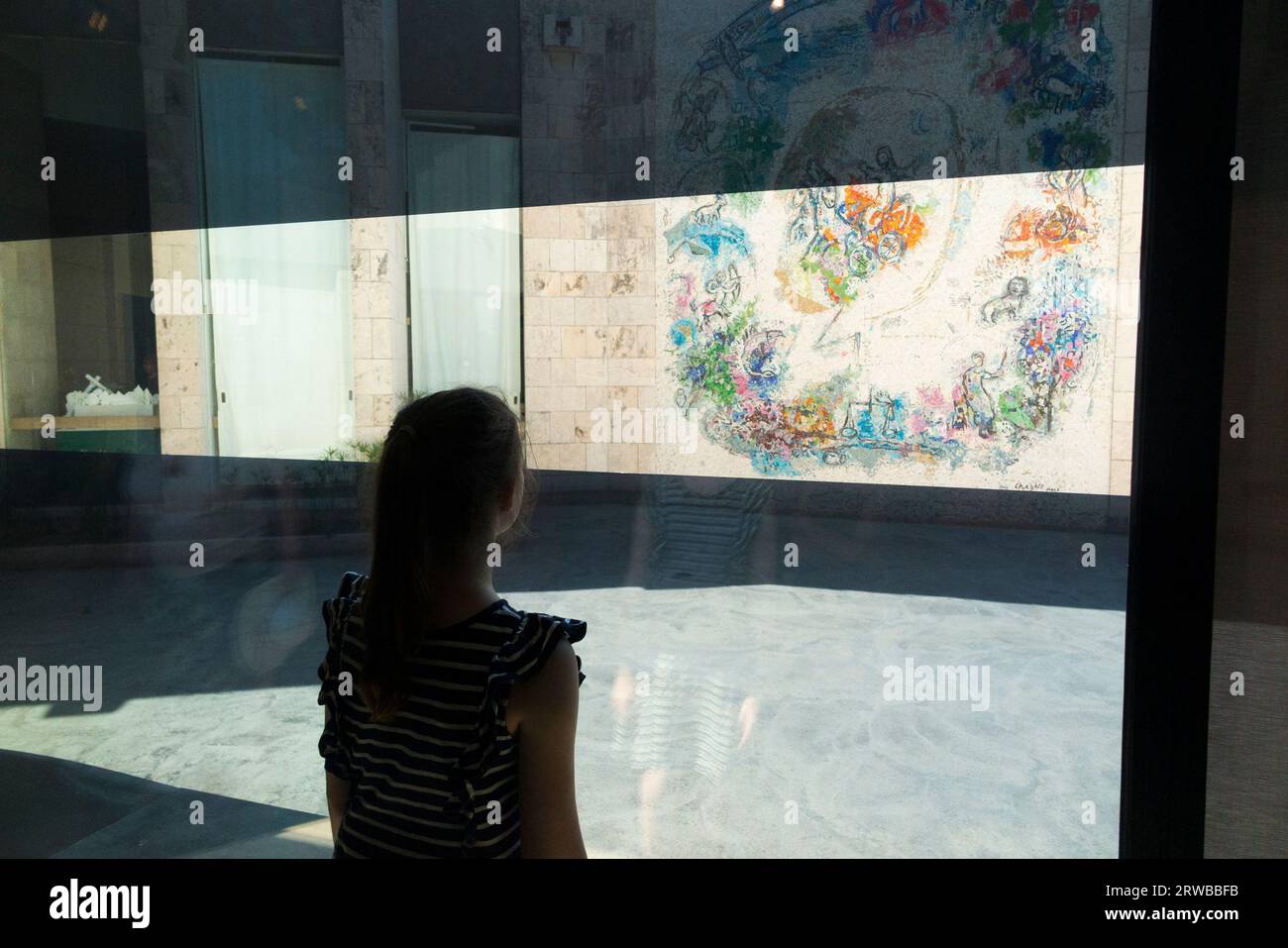 Young girl / child / kid aged 11 views & appreciates a wall mosaic by ...