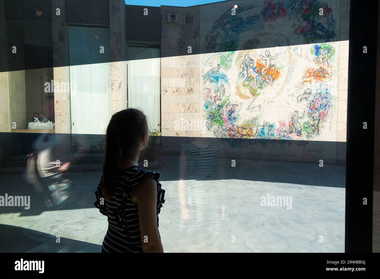 Young girl / child / kid aged 11 views & appreciates a wall mosaic by ...