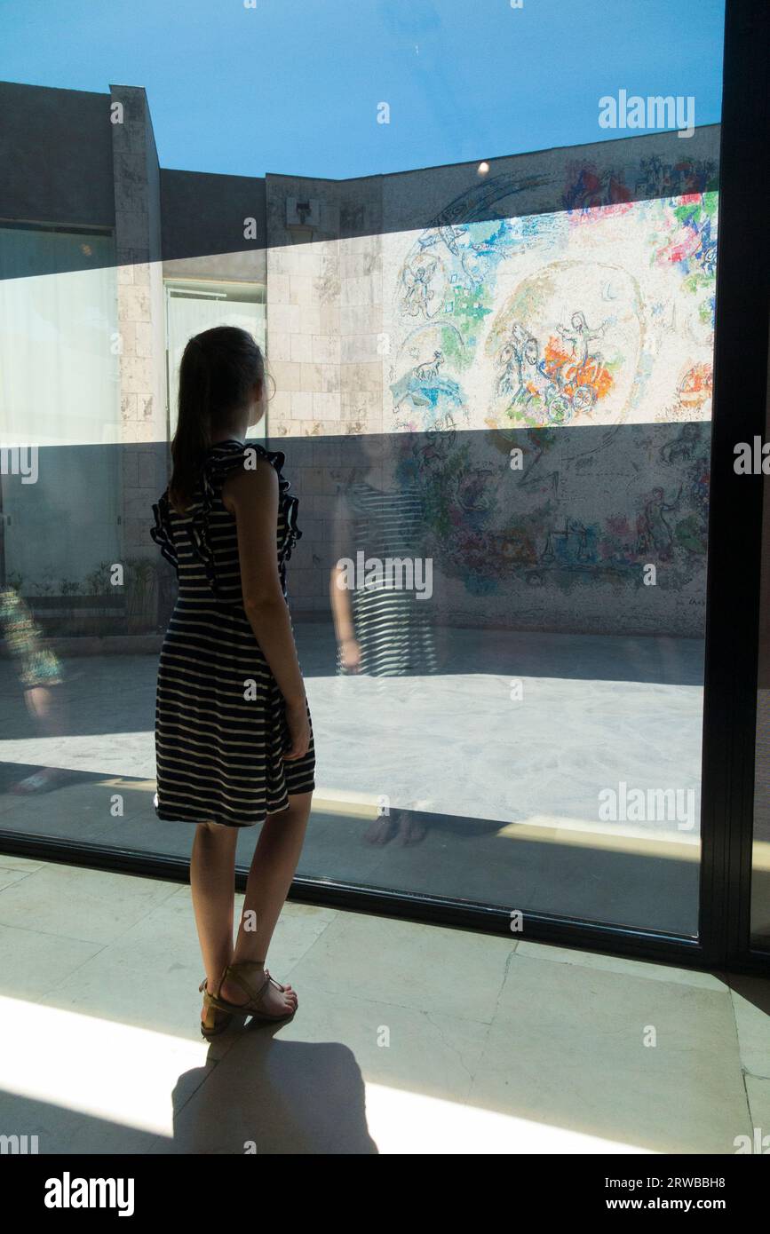 Young girl / child / kid aged 11 views & appreciates a wall mosaic by ...
