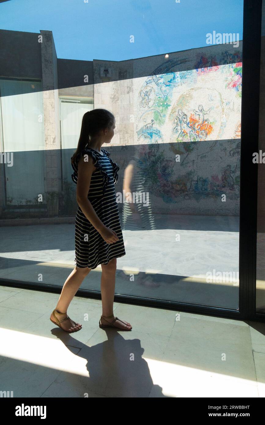 Young girl / child / kid aged 11 views & appreciates a wall mosaic by ...