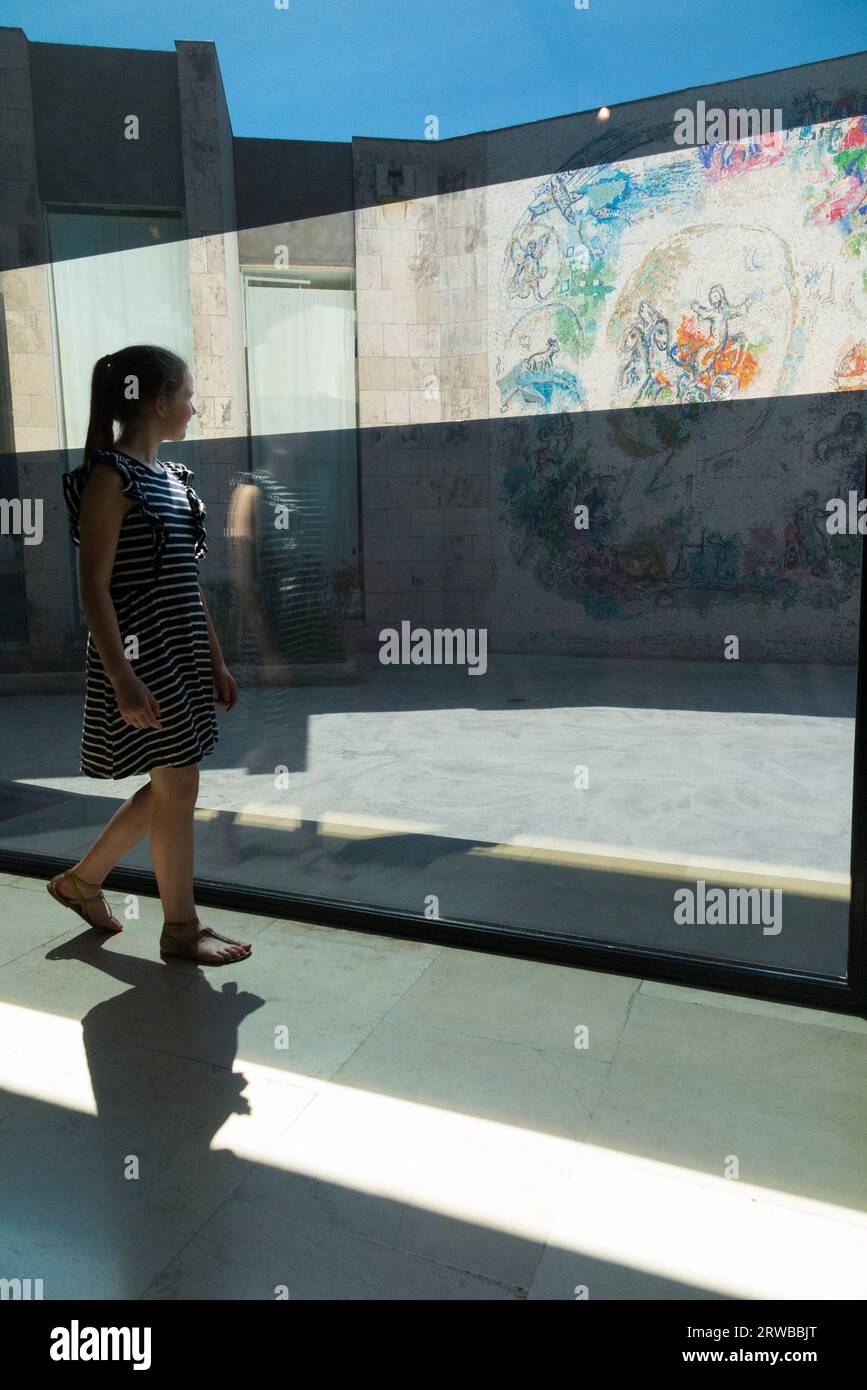 Young girl / child / kid aged 11 views & appreciates a wall mosaic by ...