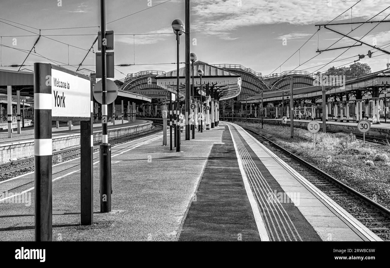 View of a railway station with a welcome place sign in the foreground ...