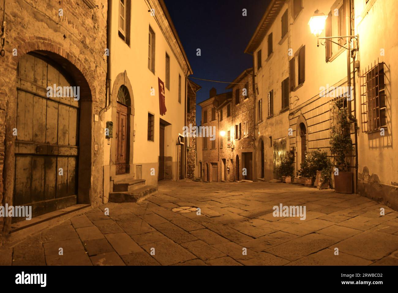 A street between the houses of Lucignano, a medieval village in Tuscany ...