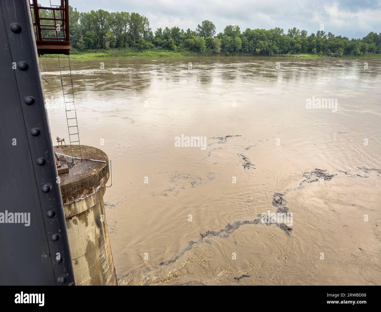 debris floating on the rising Missouri River seen from an old railroad ...