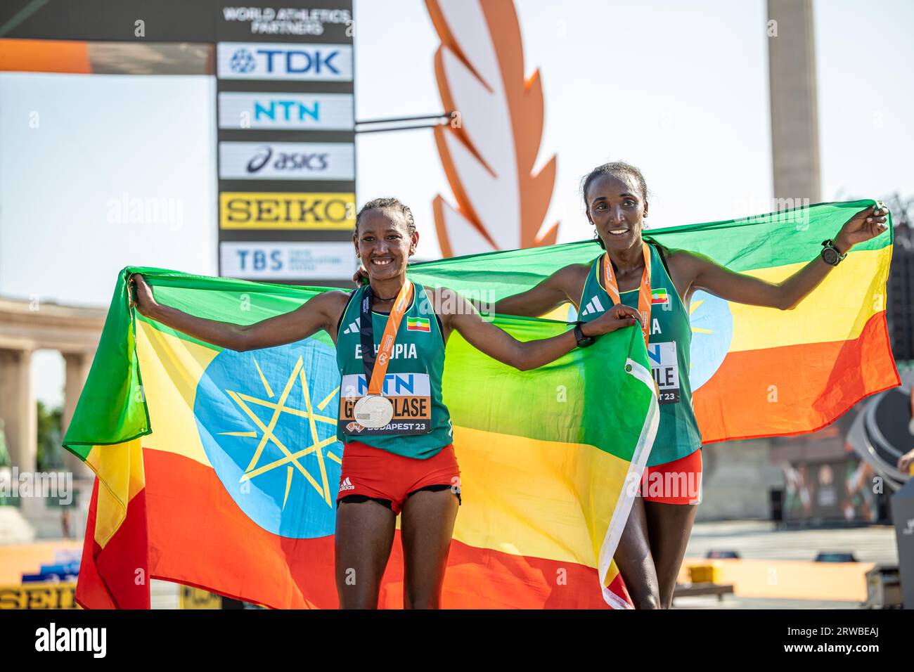 Amane Beriso SHANKULE and Gotytom GEBRESLASE with the medals and flags ...