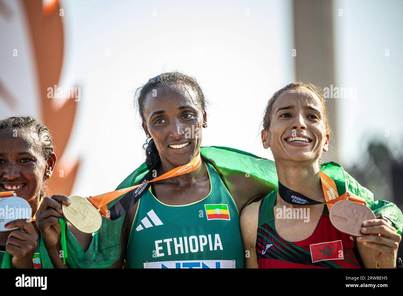Amane Beriso SHANKULE with the medals and flags of their countries in ...