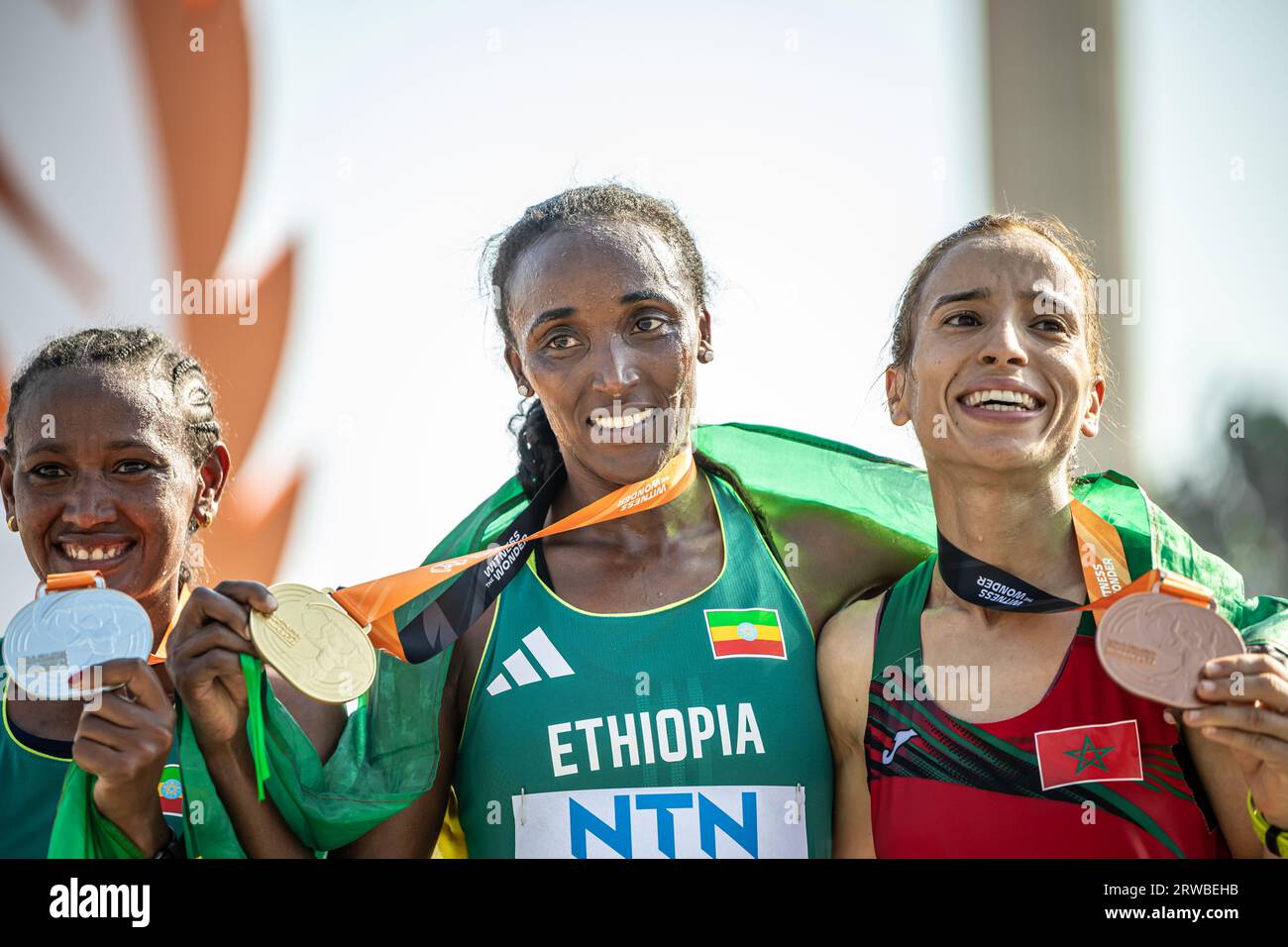 Amane Beriso SHANKULE with the medals and flags of their countries in ...