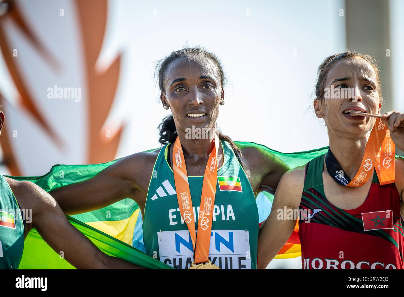 Amane Beriso SHANKULE with the medals and flags of their countries in ...
