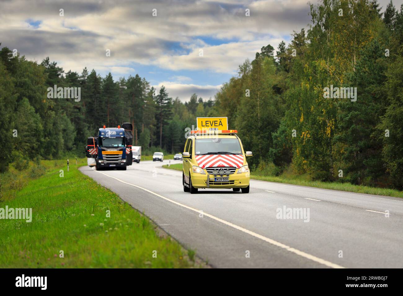 Mercedes-Benz pilot vehicle leads wide load transport pulled by a ...