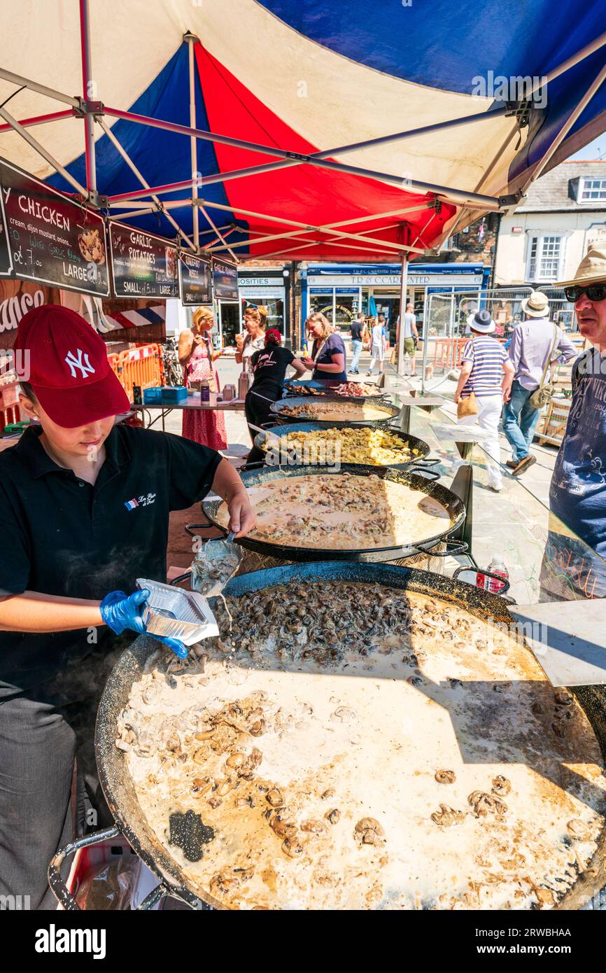 Woman working on an outdoor French food stall in the Kent town of ...