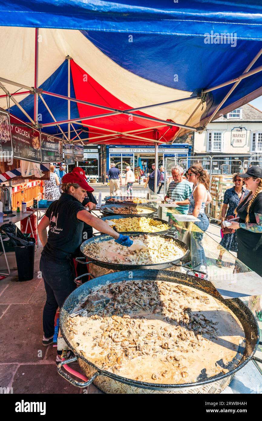 Woman working on an outdoor French food stall in the Kent town of ...