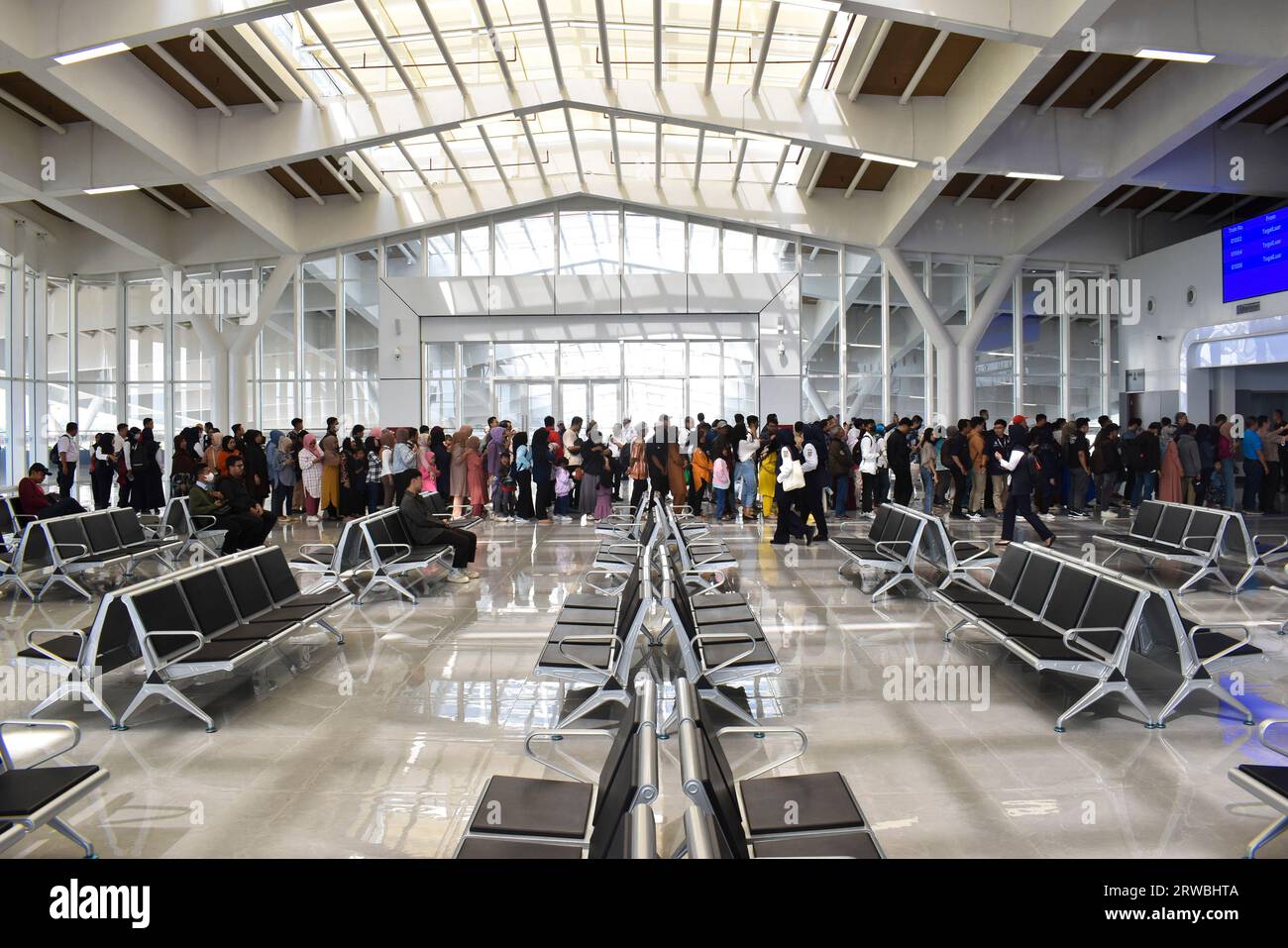 Indonesian passengers wait their turn to ride on the Jakarta-Bandung ...
