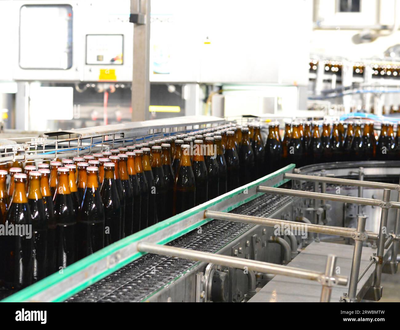beer bottles on the assembly line in a modern brewery - industrial ...