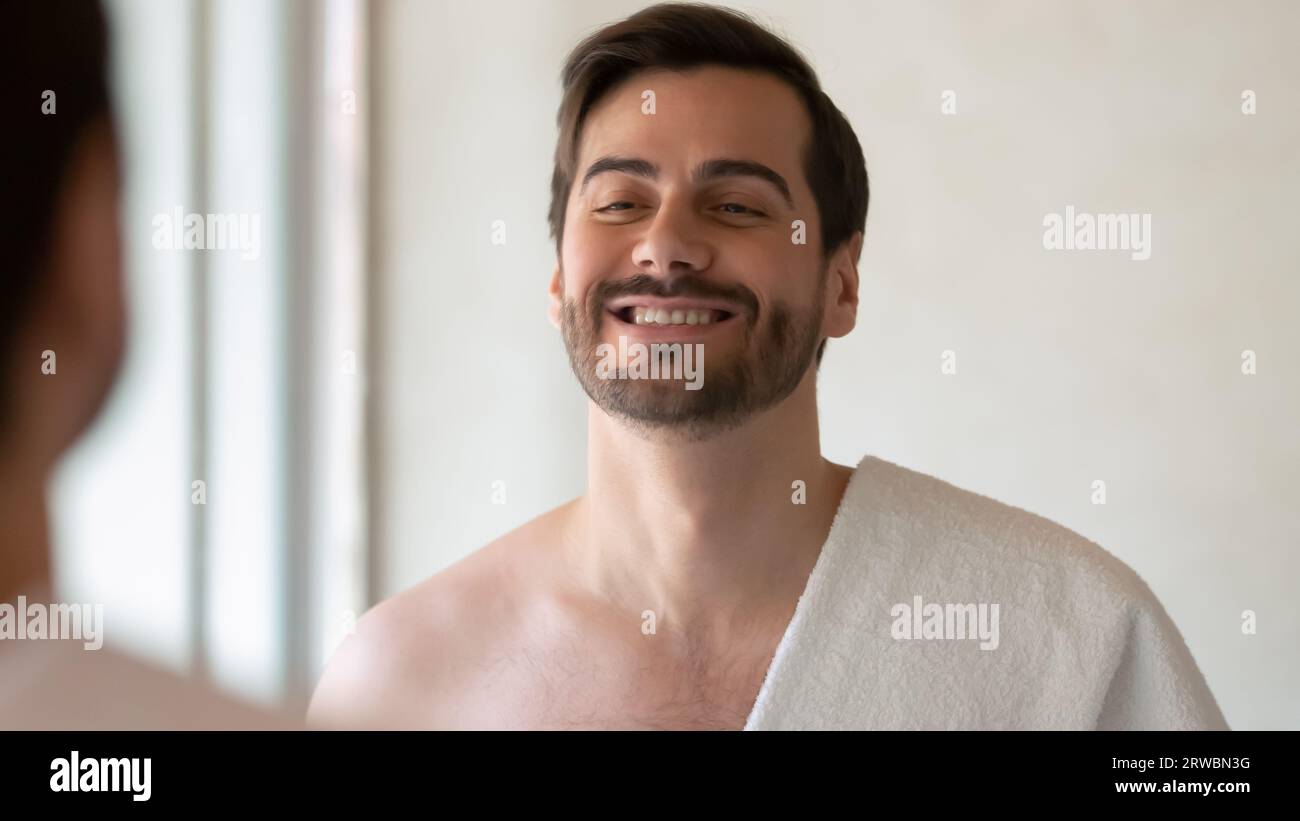 Head shot handsome man with healthy smile looking in mirror Stock Photo ...