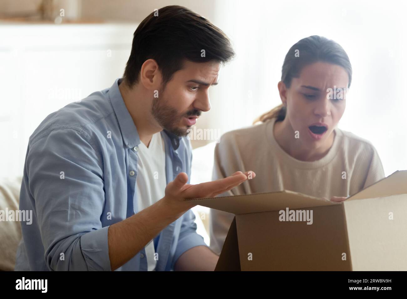 Angry man and woman annoyed by bad delivery service Stock Photo - Alamy