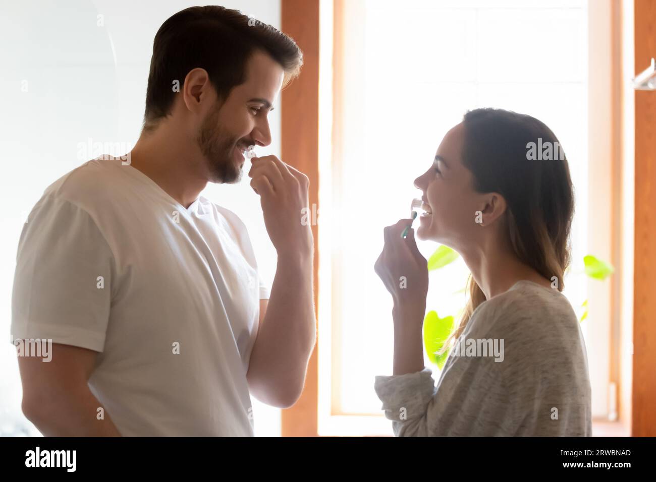 Young woman brushing teeth window hi-res stock photography and images ...