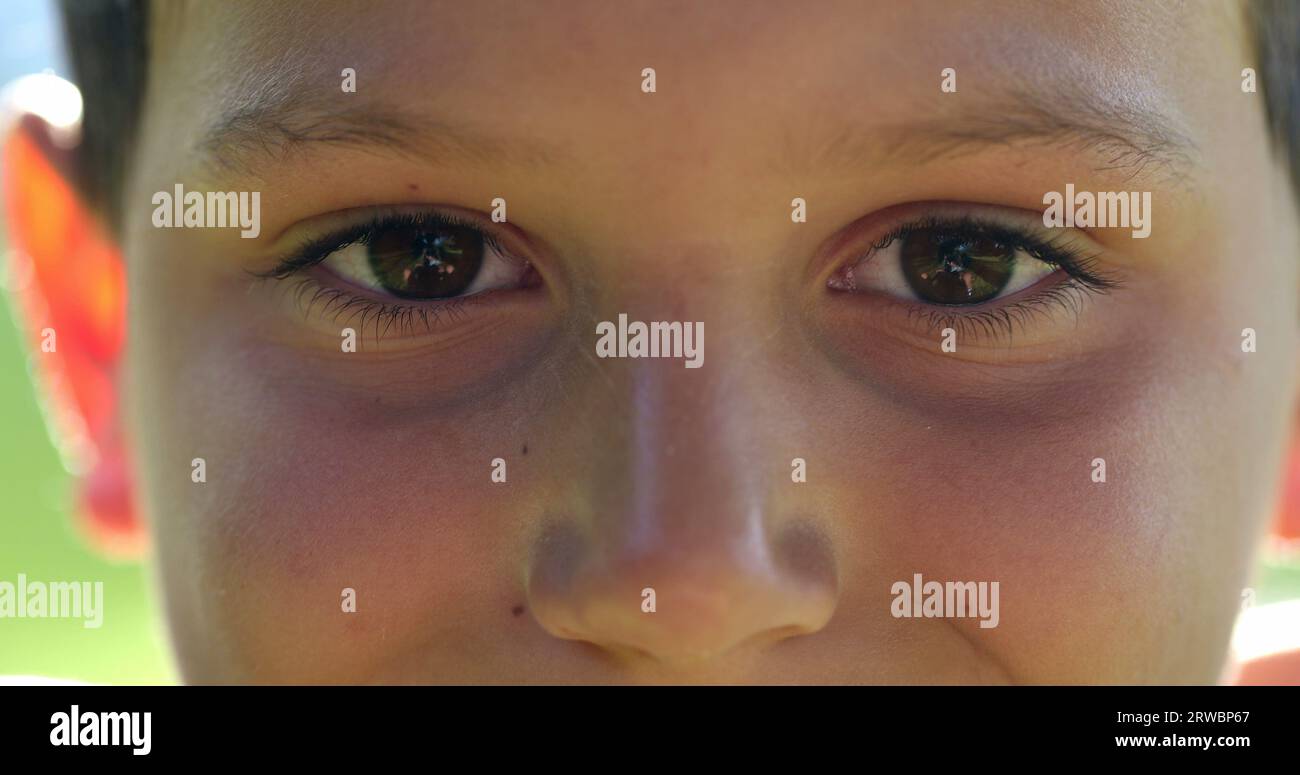 Kid face close-up closing eyes in meditation. Child boy opening eyes ...