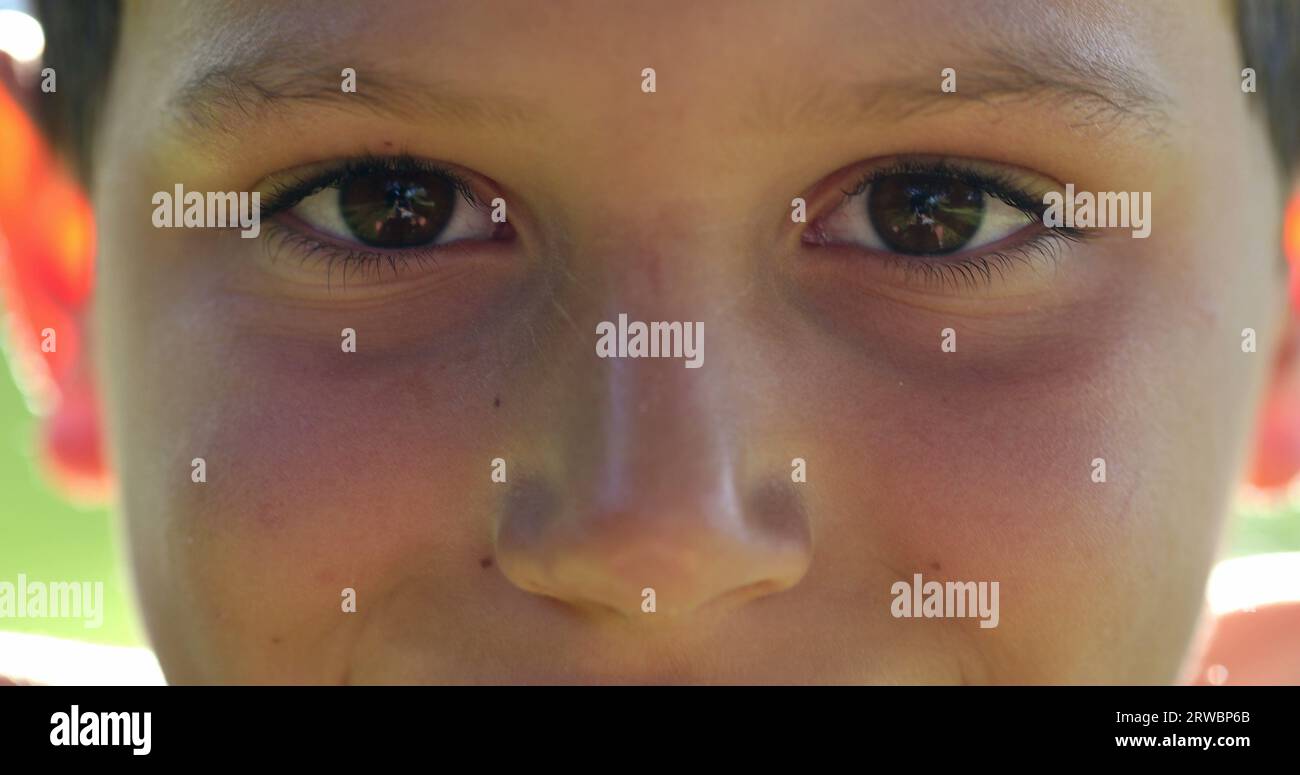 Kid face close-up closing eyes in meditation. Child boy opening eyes ...
