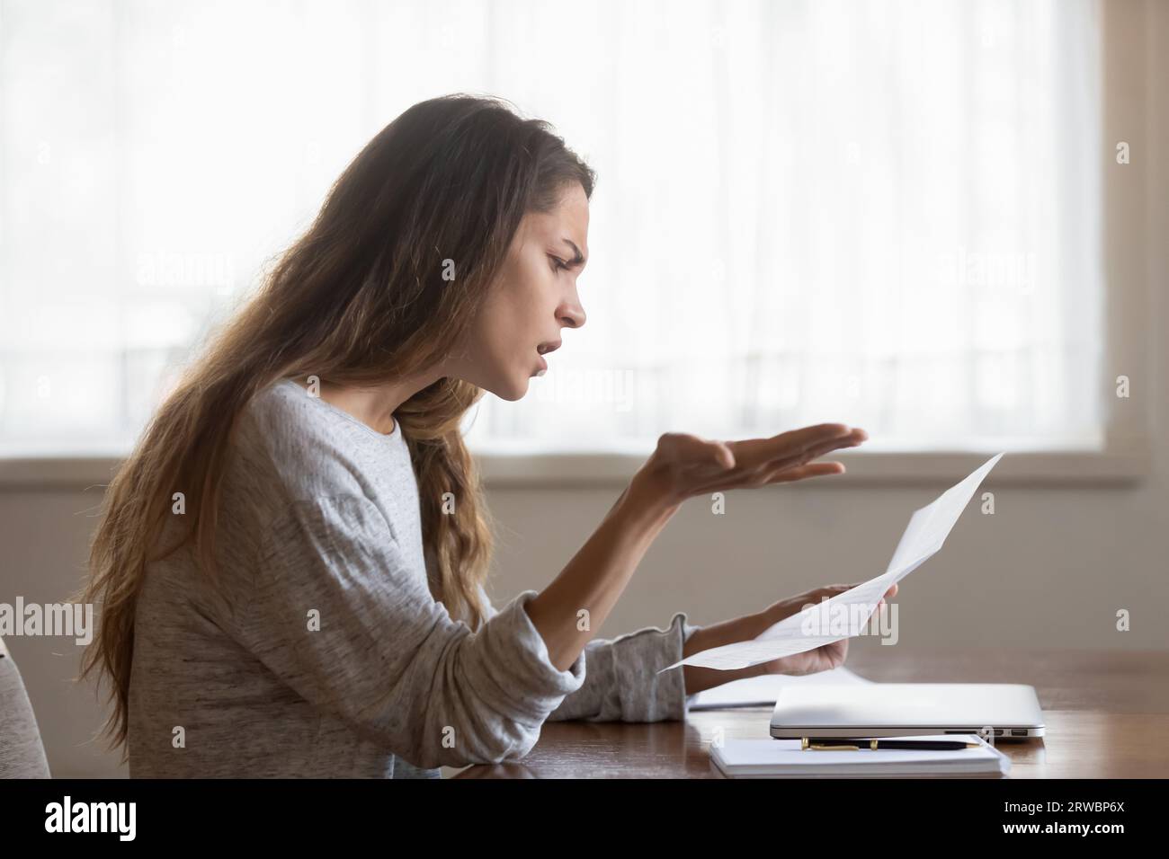Worried woman holding bank letter hi-res stock photography and images ...