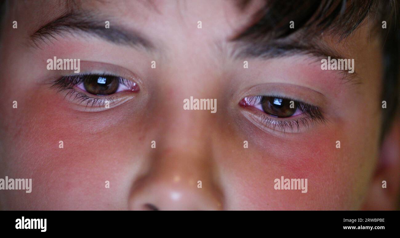 Macro child boy eyes staring at screen light at night, kid browsing ...