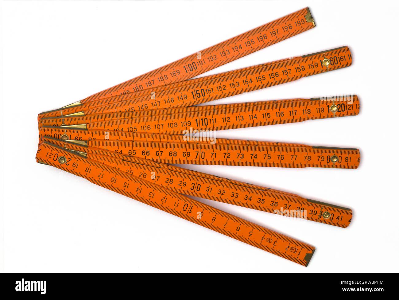 An orange folding ruler on the white surface: collapsible measuring ...