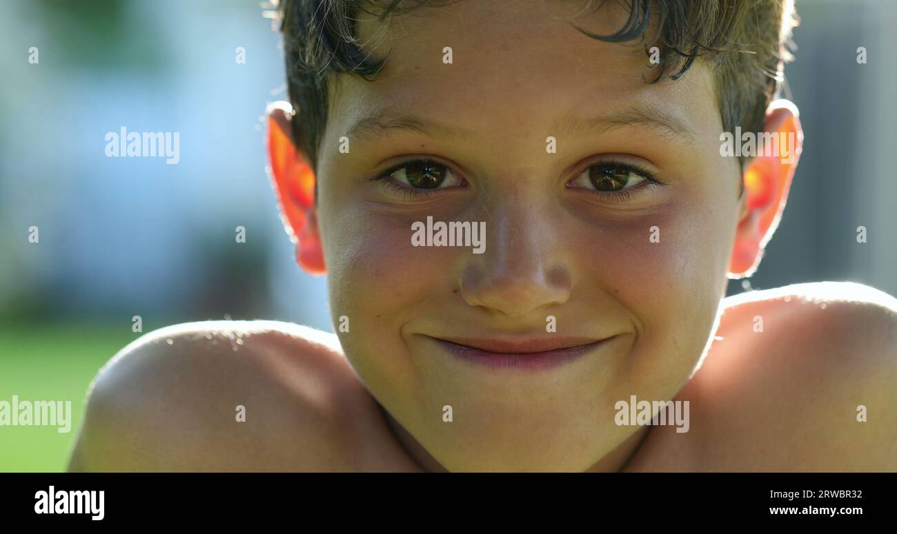 Handsome young boy child face smiling feeling happy and joy in outdoor ...