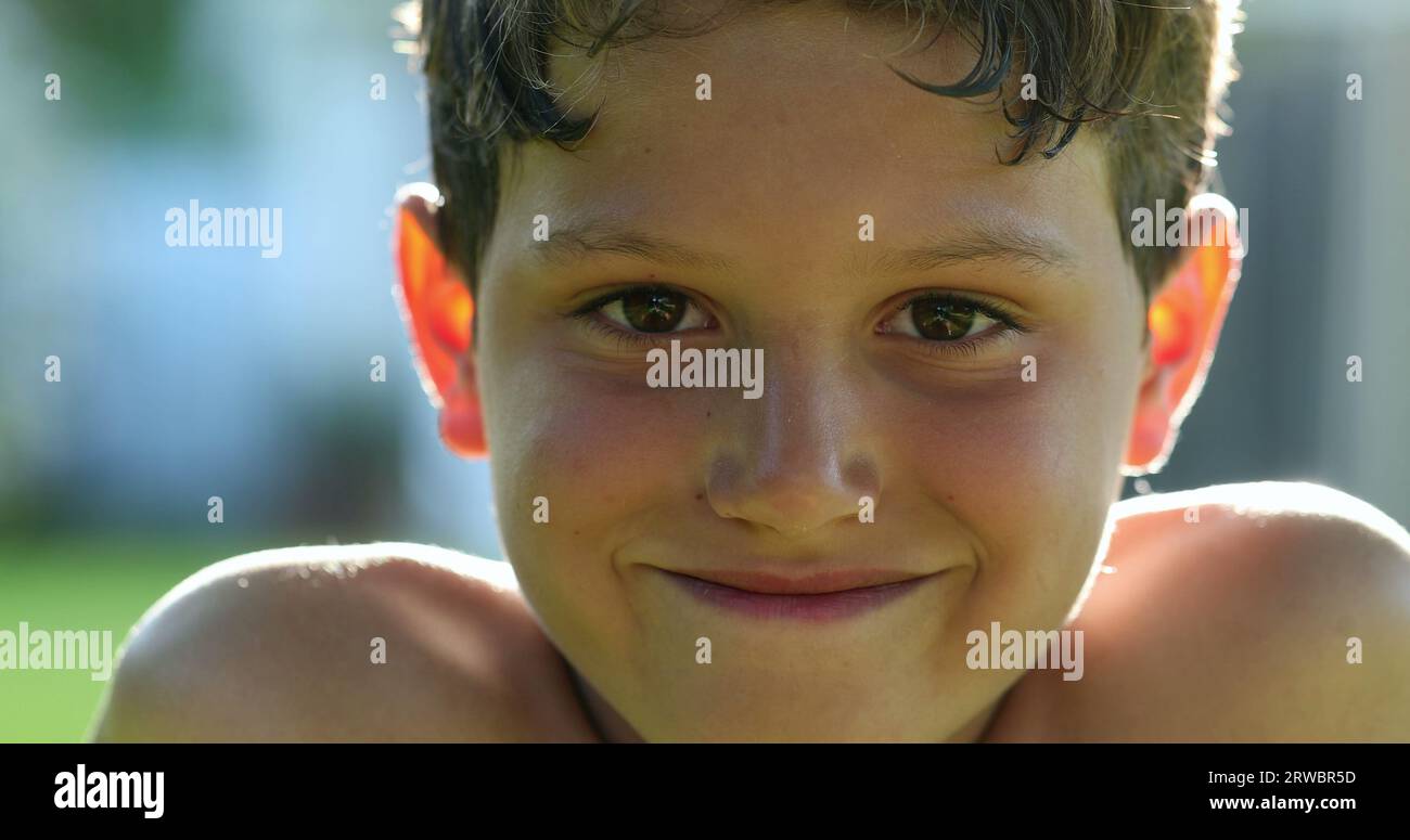 Handsome young boy child face smiling feeling happy and joy in outdoor ...