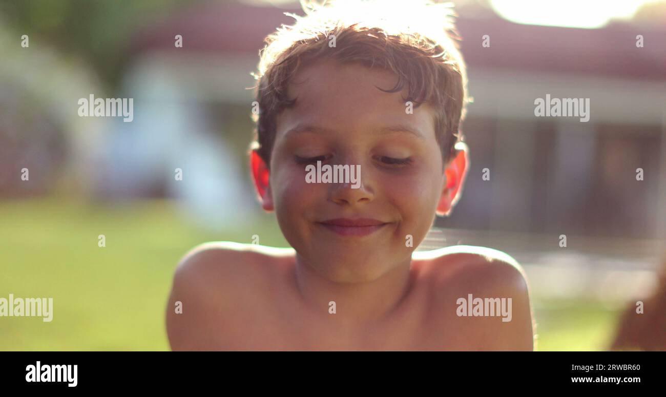 Handsome young boy staring to camera outside in nature. Portrait of ...