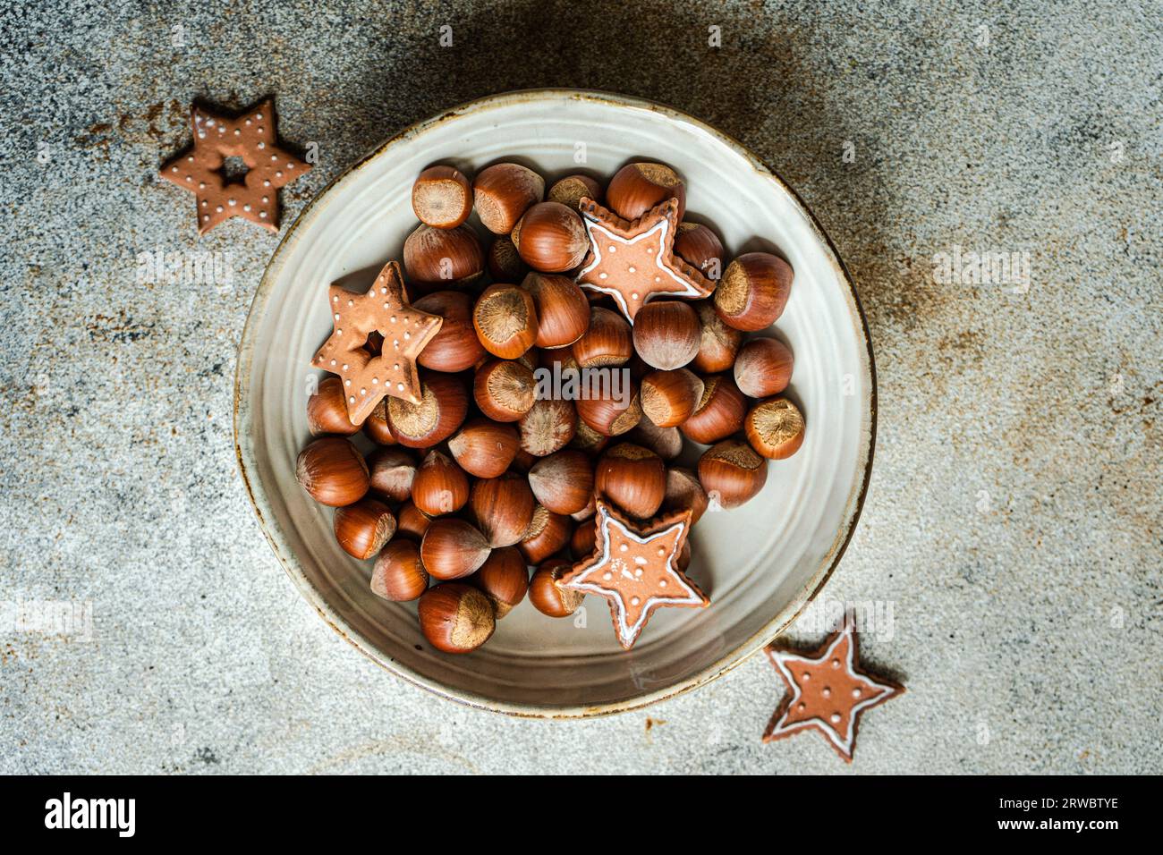From above of plate of heap of chestnuts with tasty Christmas cookies ...