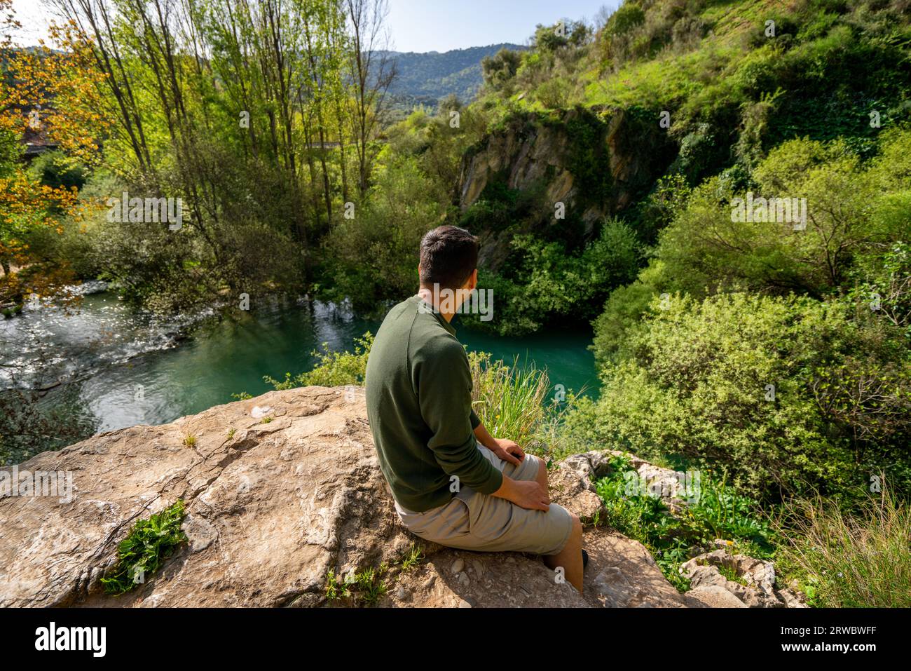 From above back view male tourist admiring transparent clear rippling ...