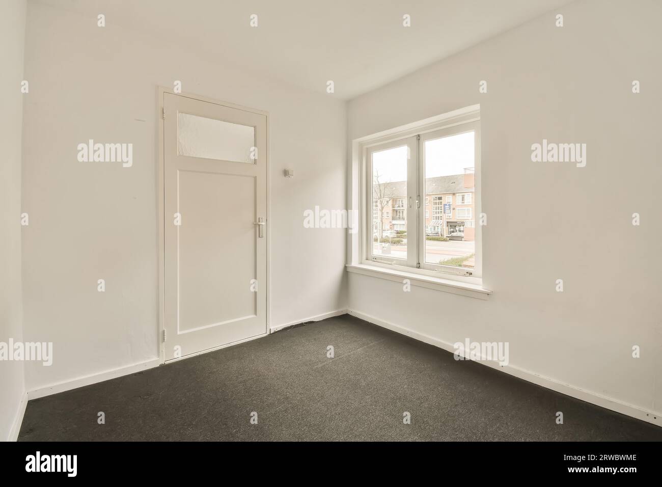 Interior of empty room with closed doors and light window in ...