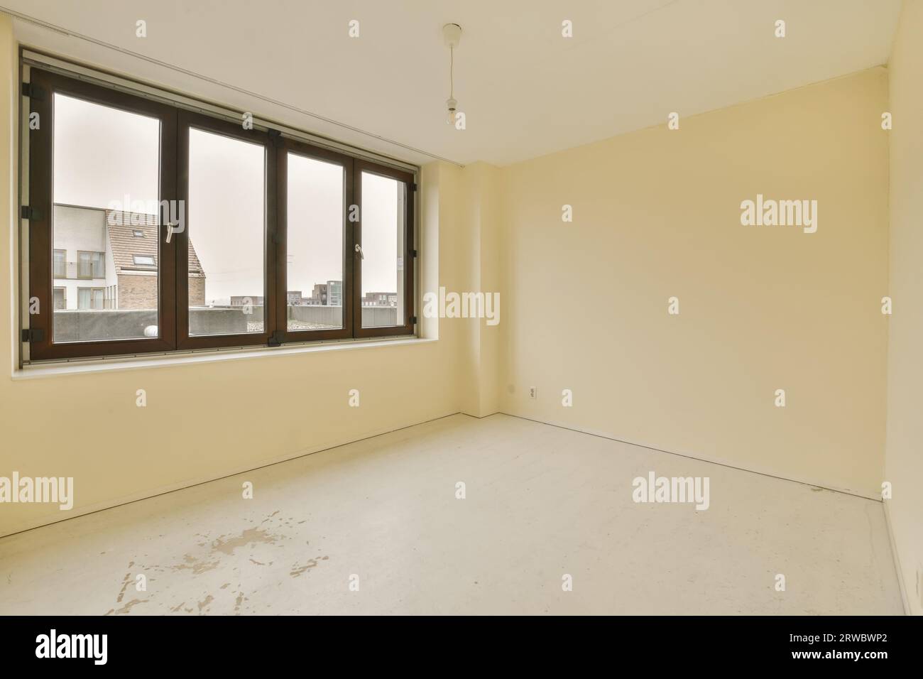 Interior of empty room with bright large windows and beige walls in ...