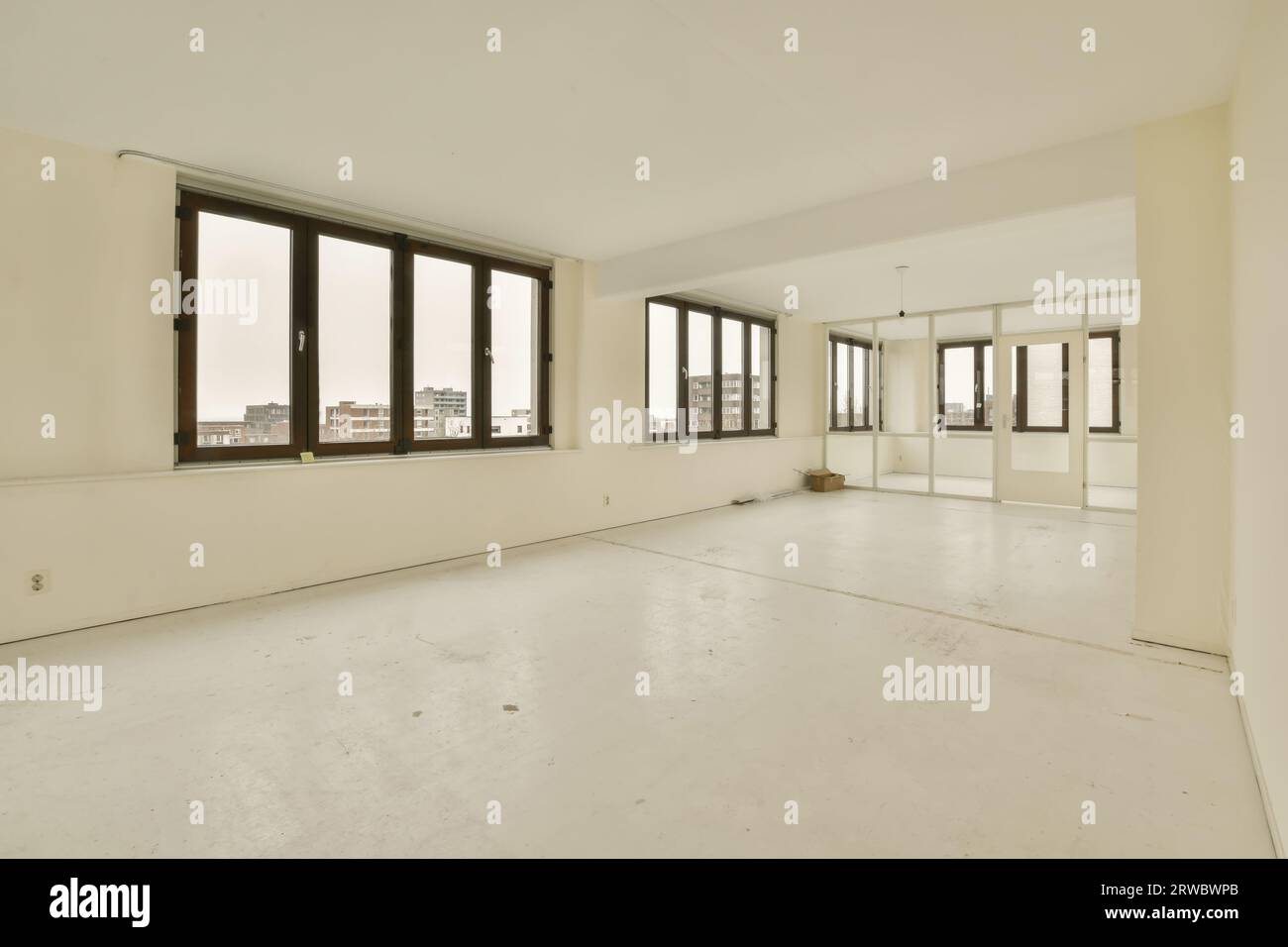 Interior of spacious empty room with large windows and mirror with ...