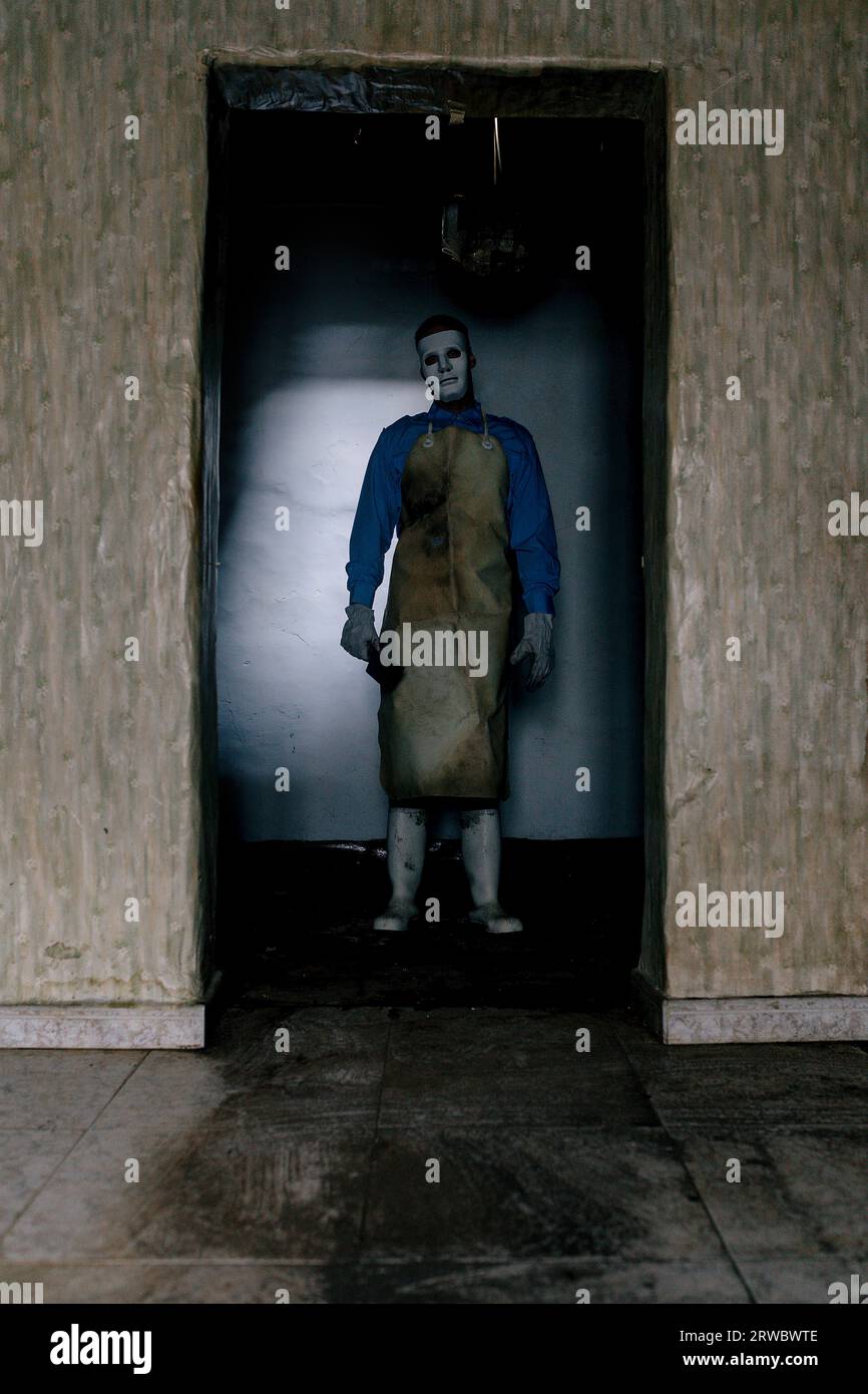 Anonymous terrifying man in butcher costume with apron and knife ...