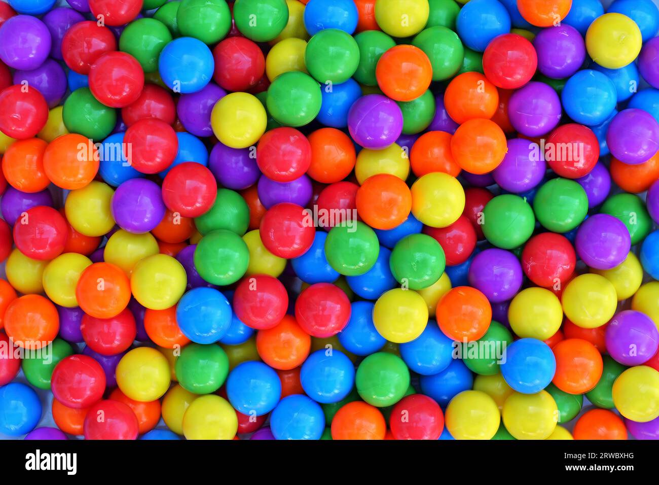 Colorful marbles from a game captivate within a decorative surface ...