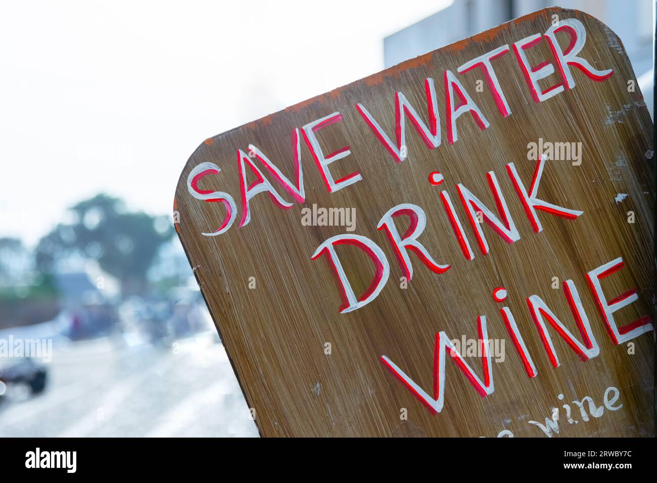 Save Water. Drink wine. Wooden desk Stock Photo - Alamy
